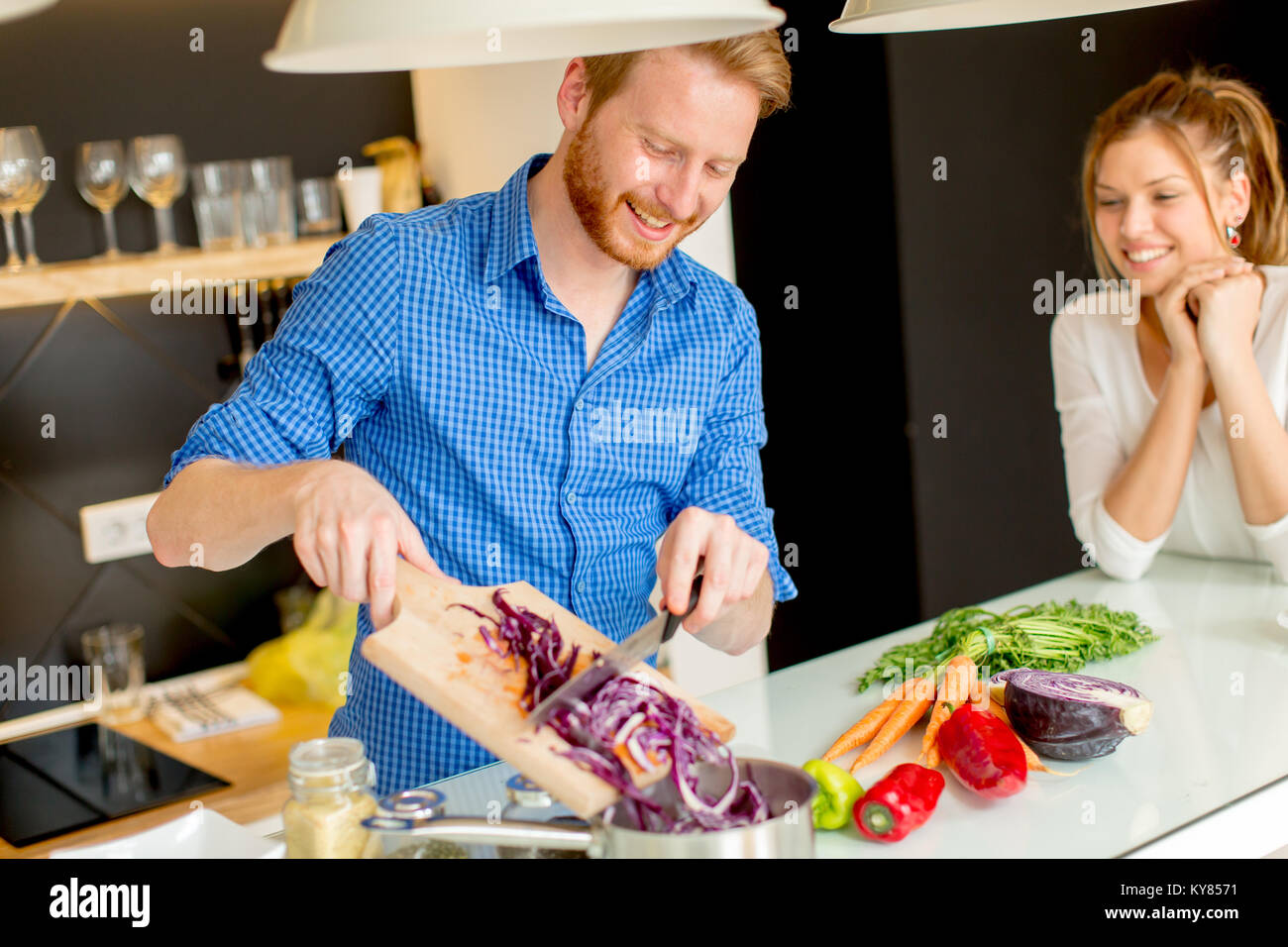Lovely Young Couple Preparing Healthy Meal In The Modern Kitchen Stock