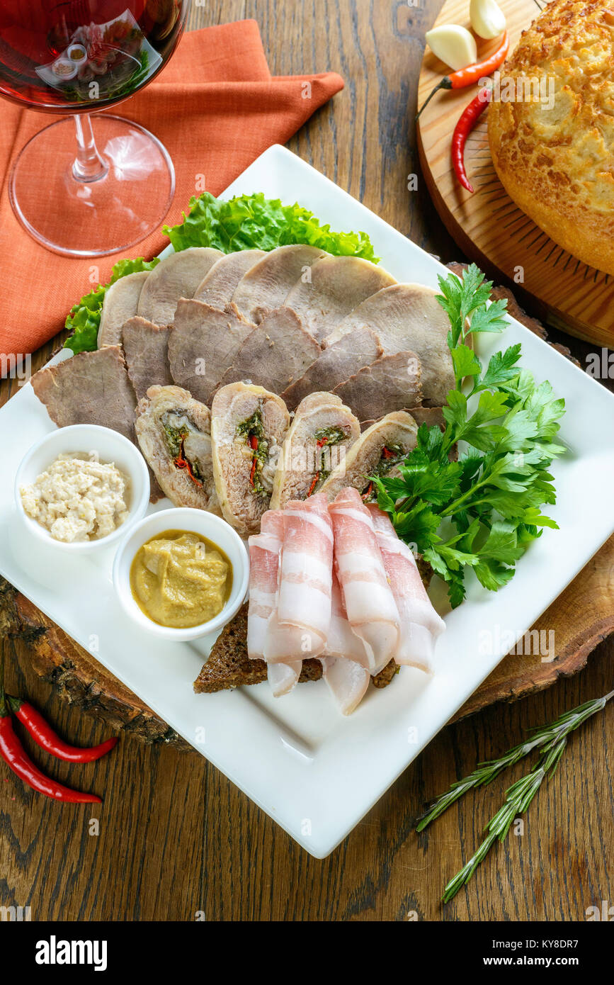 Set of different meat cut garnished on white square plate Stock Photo ...