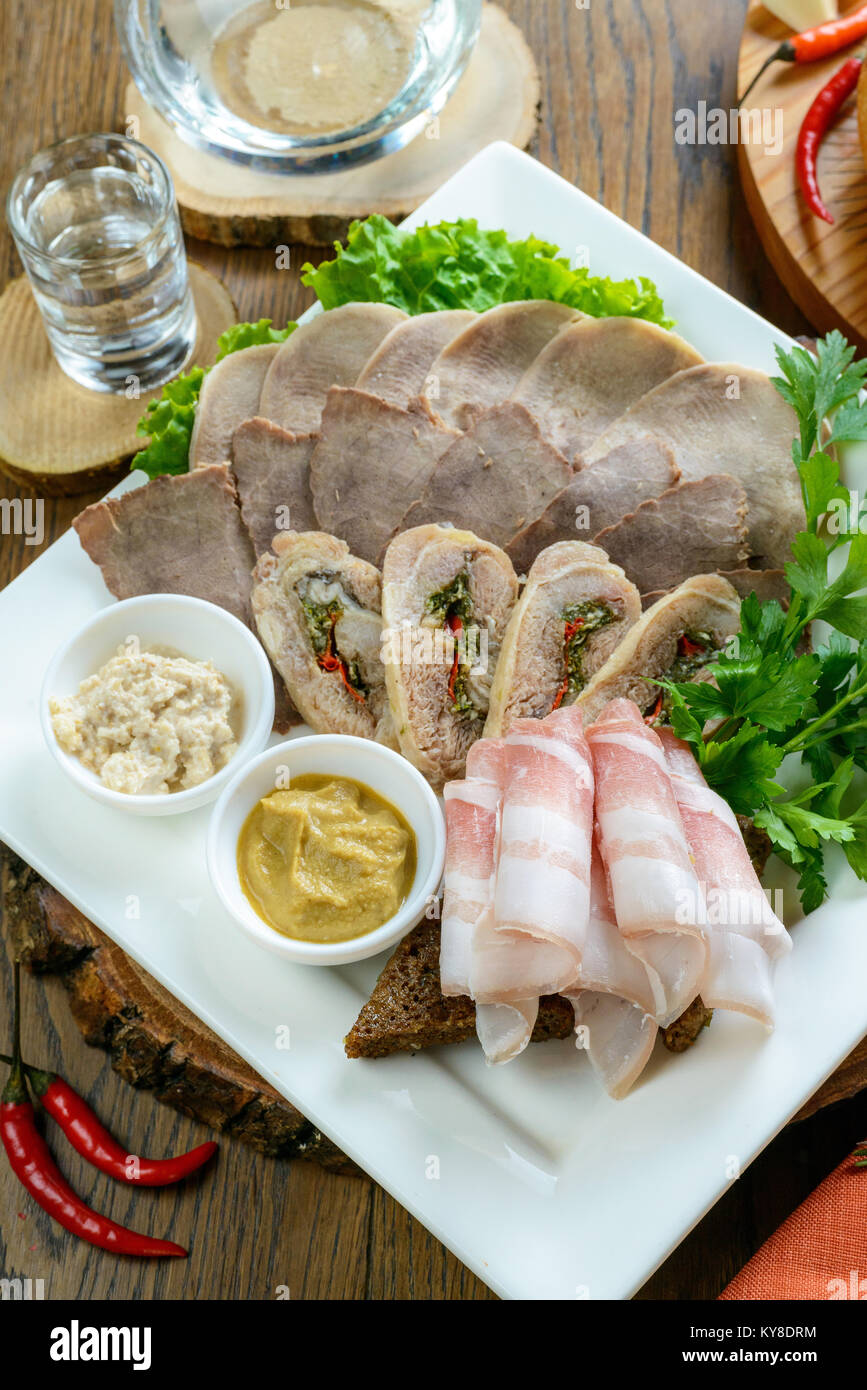 Set of different meat cut garnished on white square plate Stock Photo ...