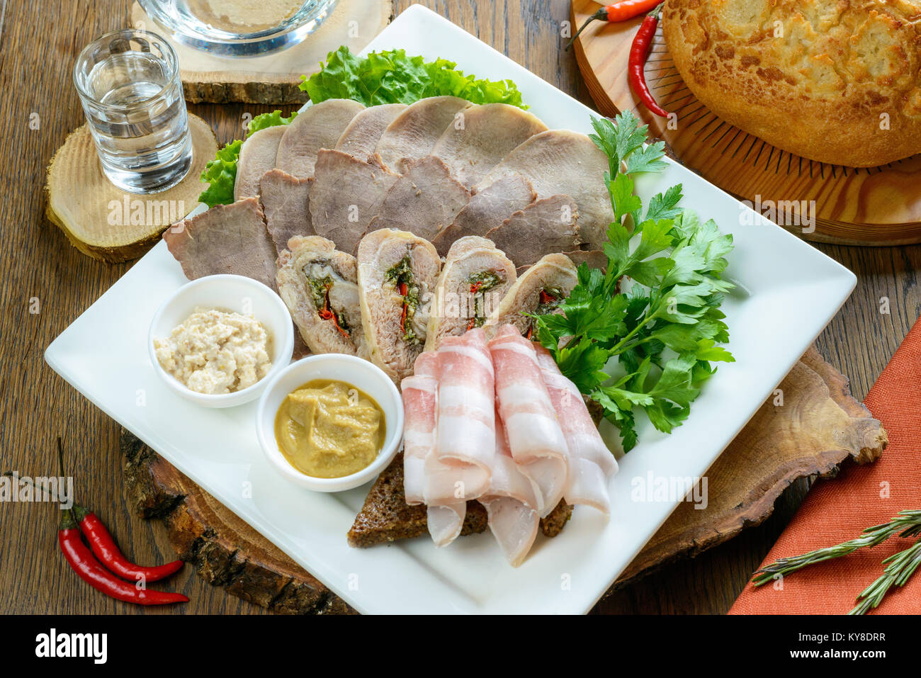 Set of different meat cut garnished on white square plate Stock Photo ...