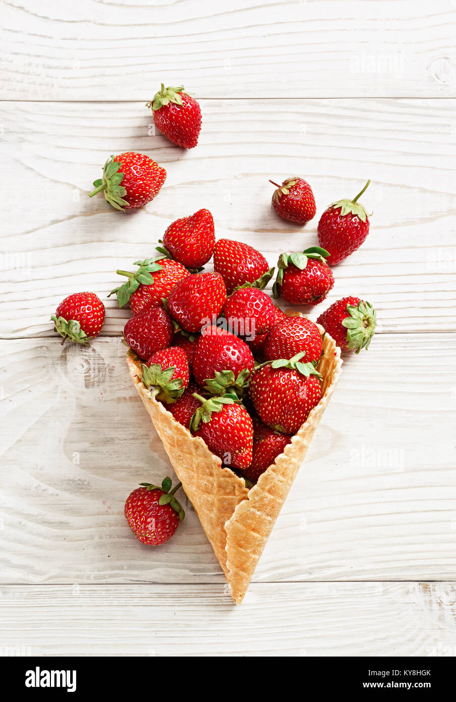 Strawberry explosion. Photo of strawberry in waffle cone on white ...