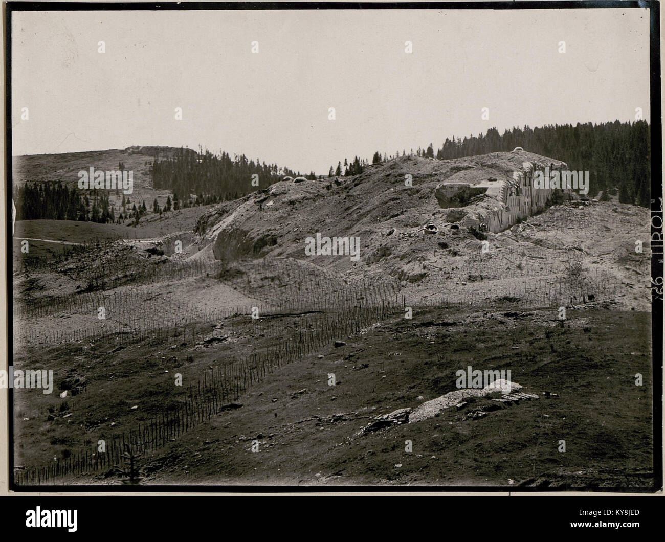 The image depicts a destroyed military bunker with a tank turret lying ...