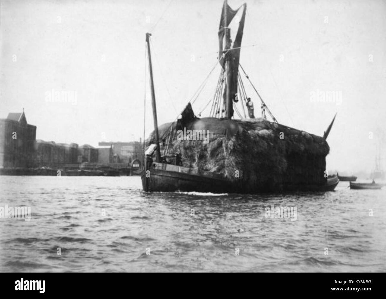 This historical image shows the hay barge ‘Unity’ navigating past ...