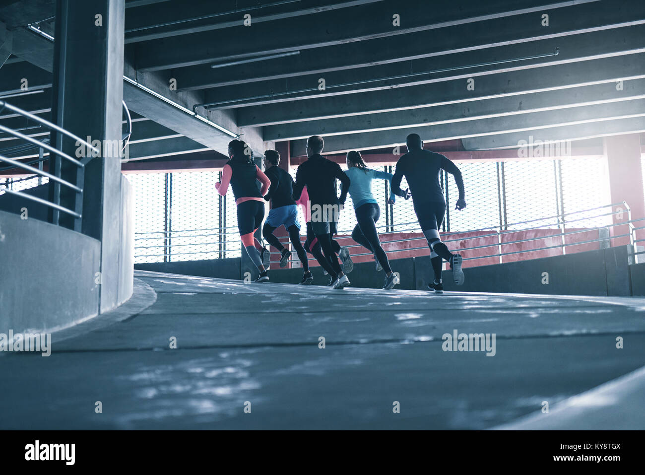 Back view of team practising together in parking place. Copyspace Stock ...