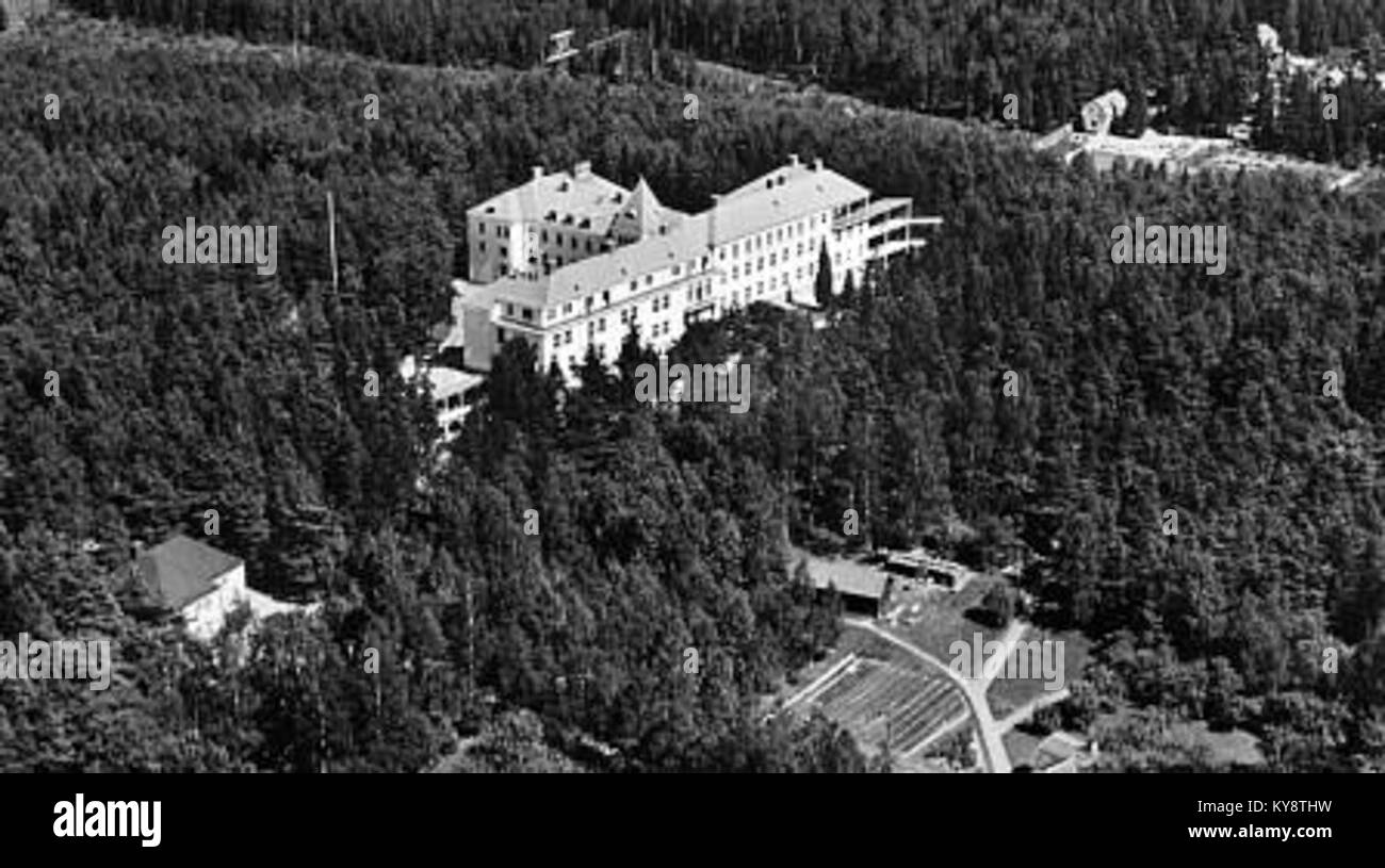 This image features a historical photograph of a sanatorium, capturing ...