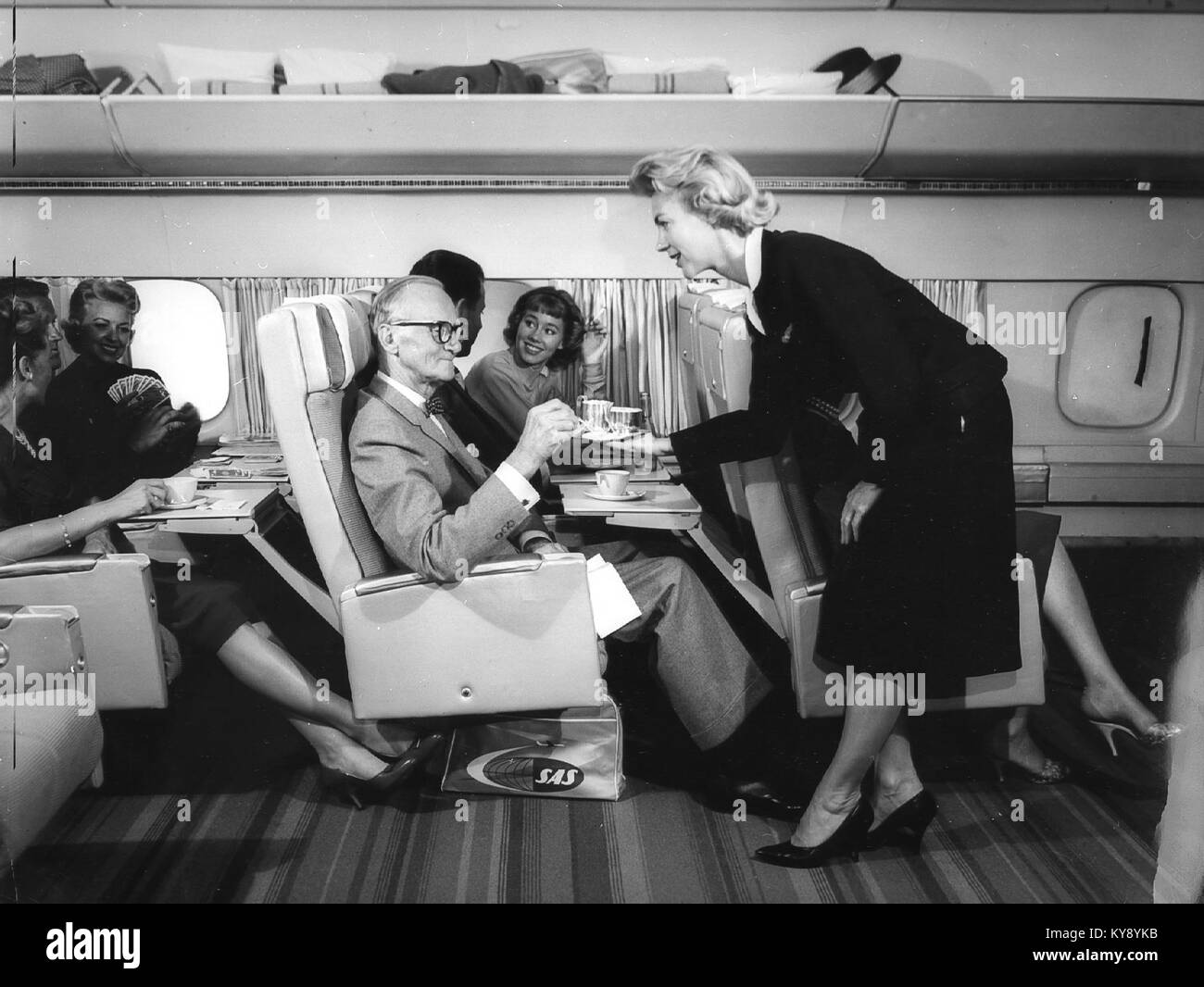 Photograph of in-flight service on a DC-8 aircraft, showing flight ...