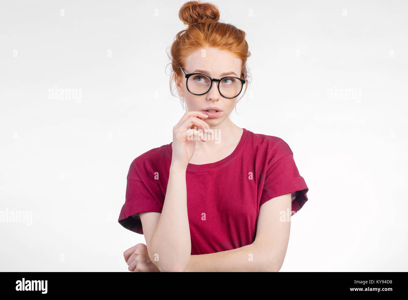 Redhead Girl Wearing Glasses With Hair Knot And Freckles Looking