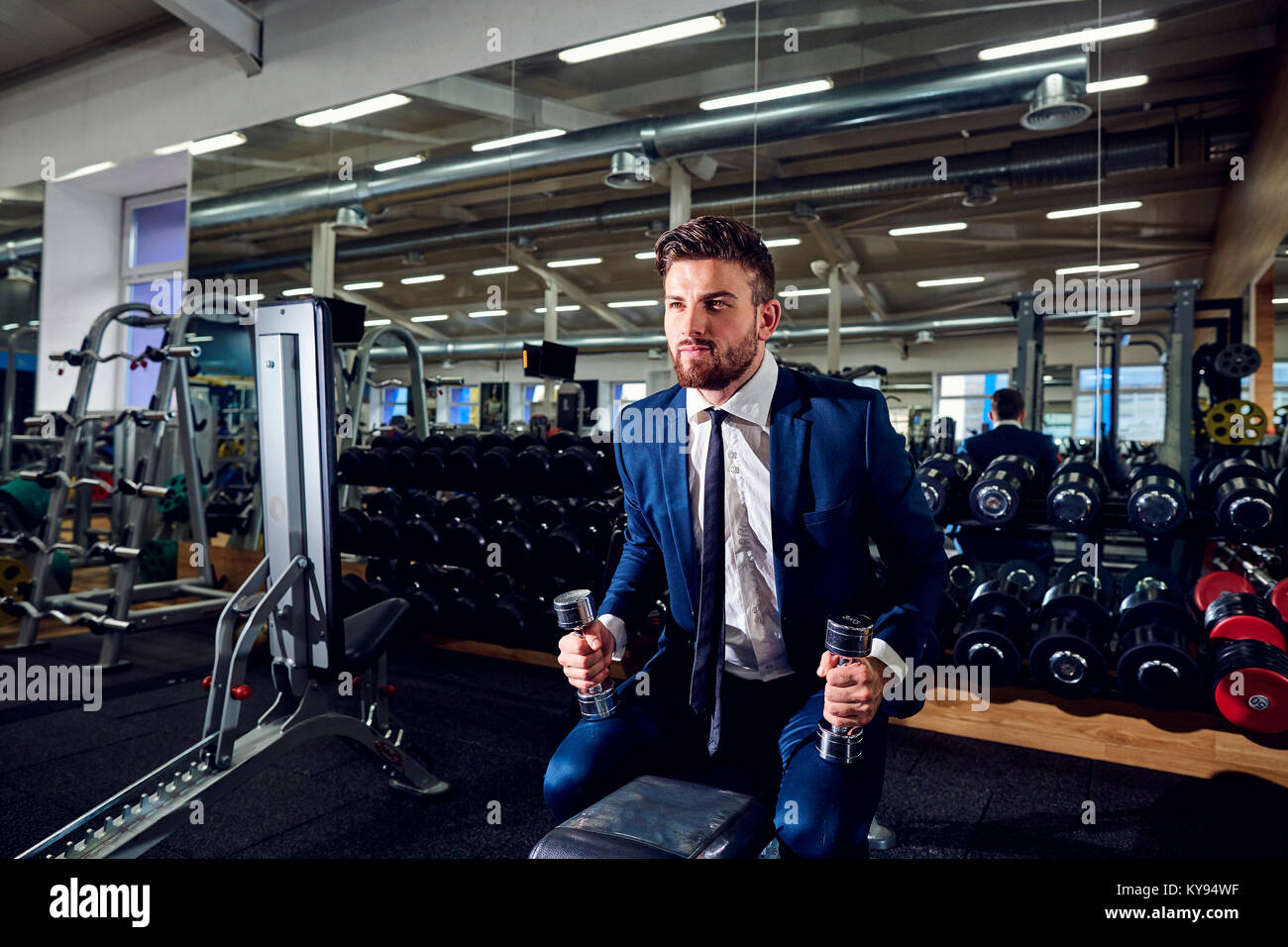 Businessman doing exercises with dumbbells Stock Photo - Alamy
