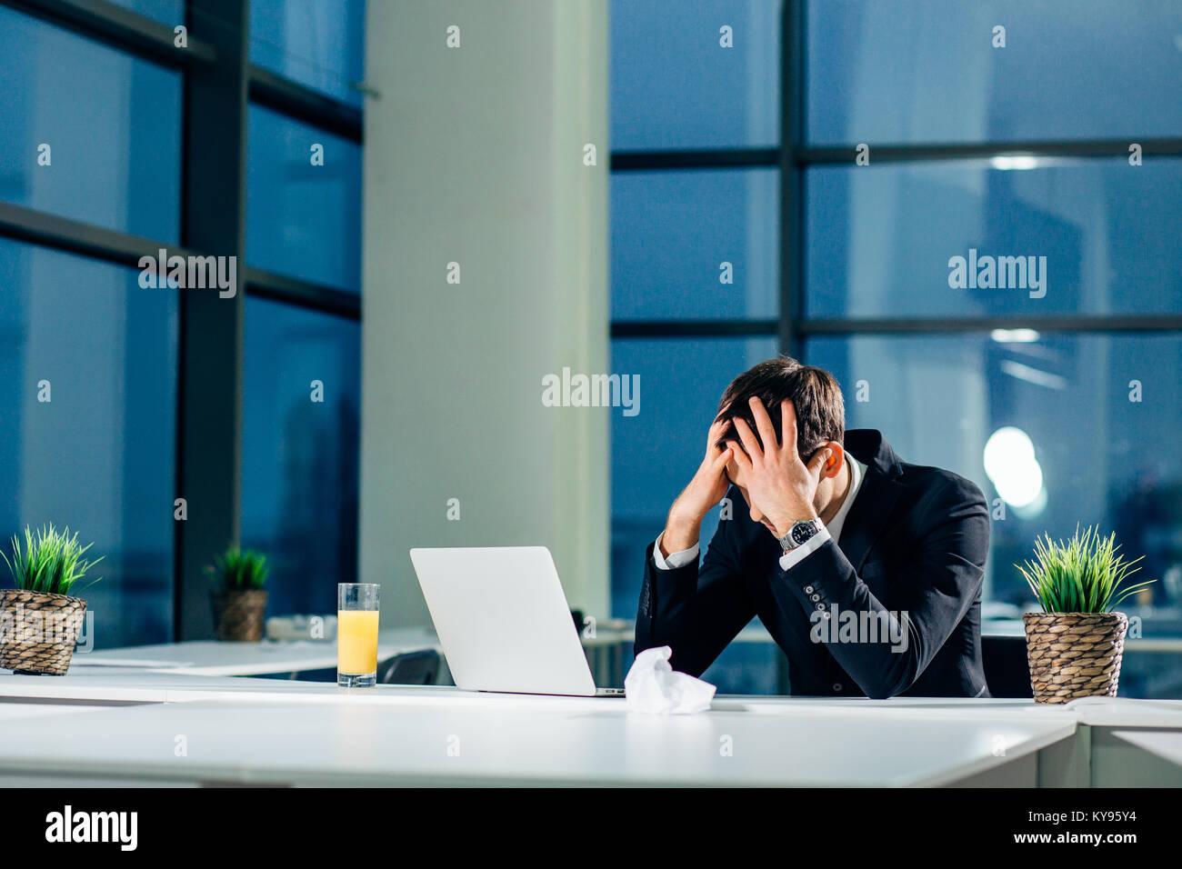 Stressed businessman having problems and headache at work Stock Photo ...