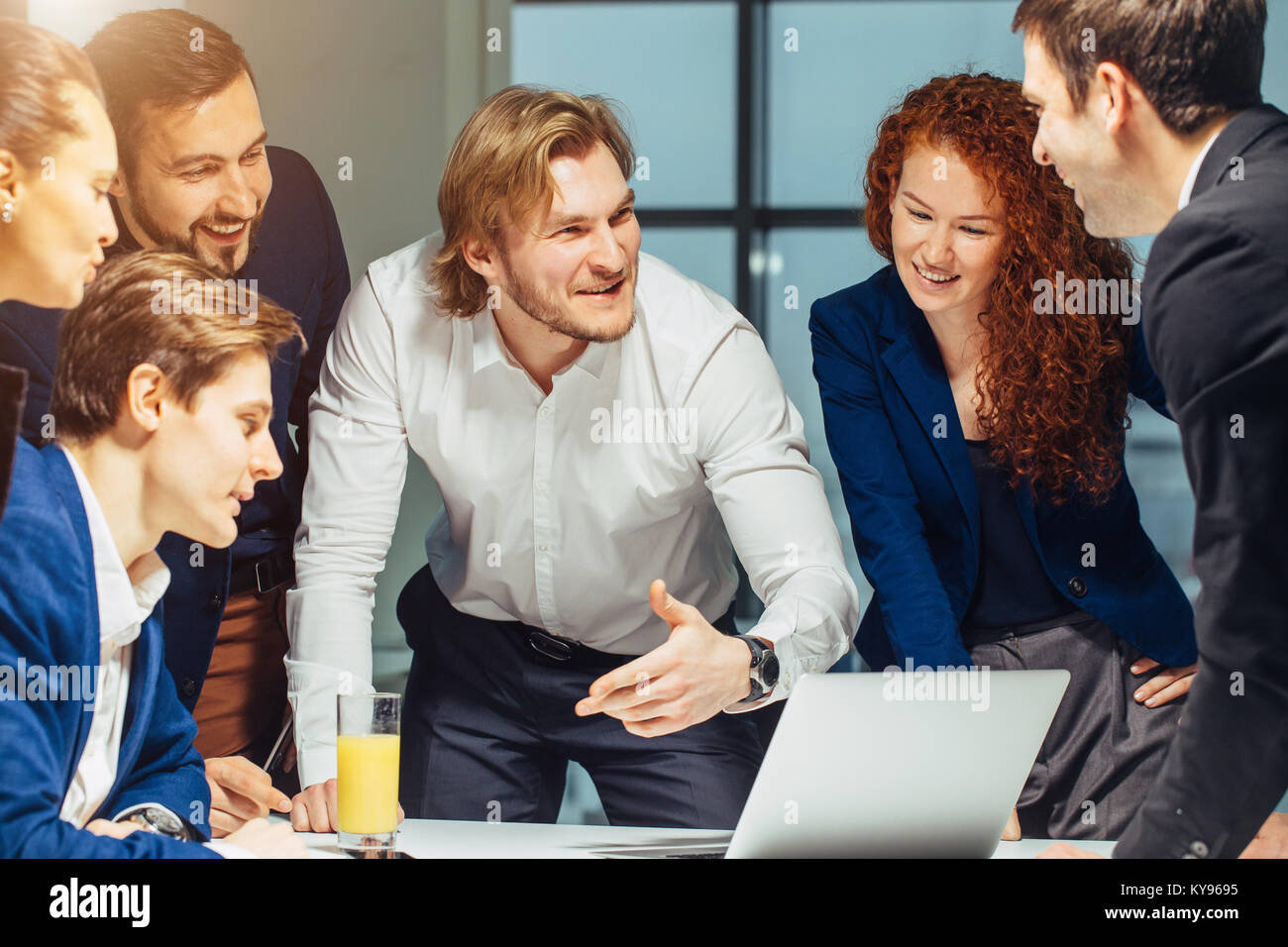 male and female business people around laptop computer in office Stock ...
