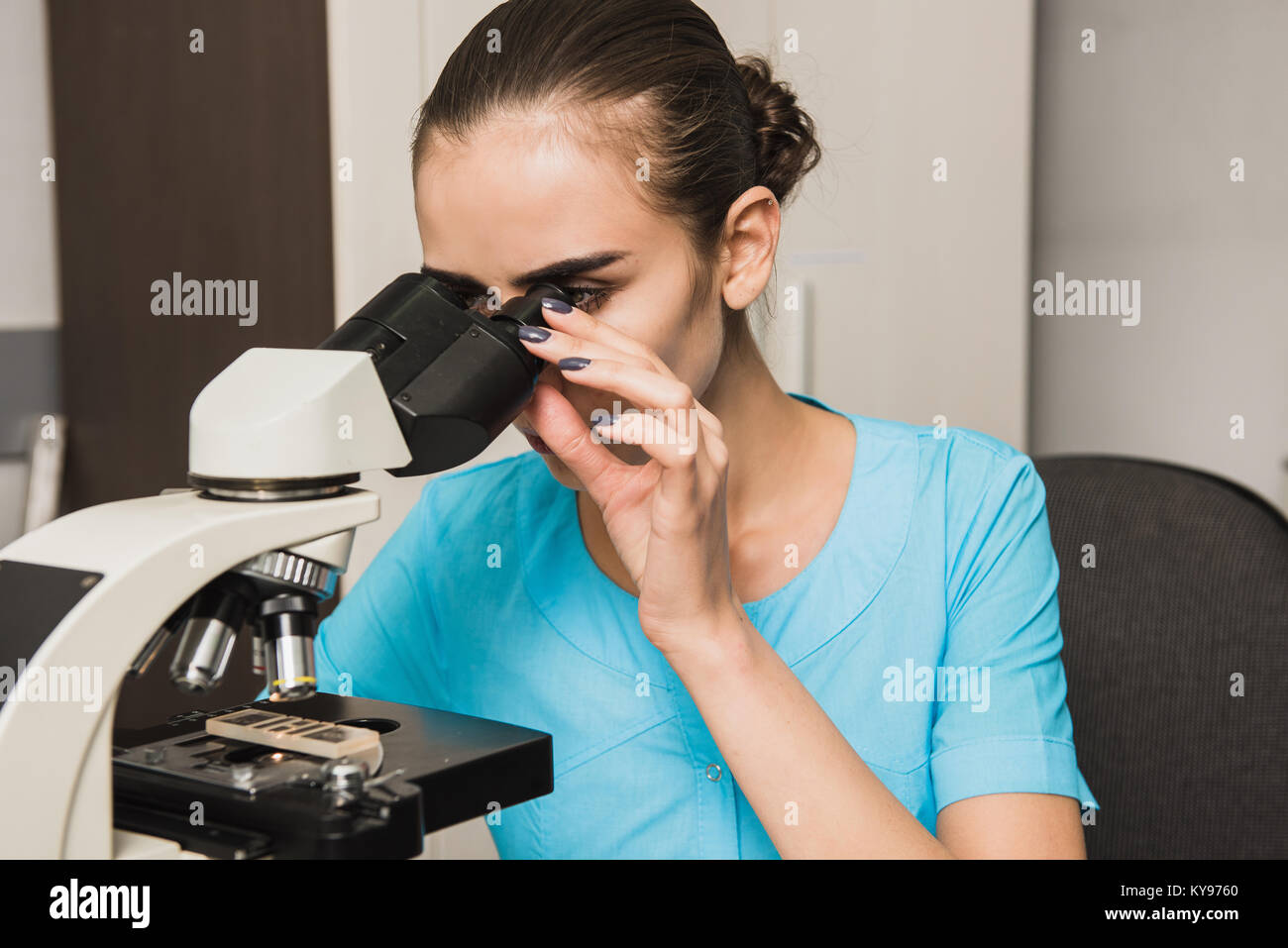 Female researcher with a microscope. Laboratory in the Veterinary ...