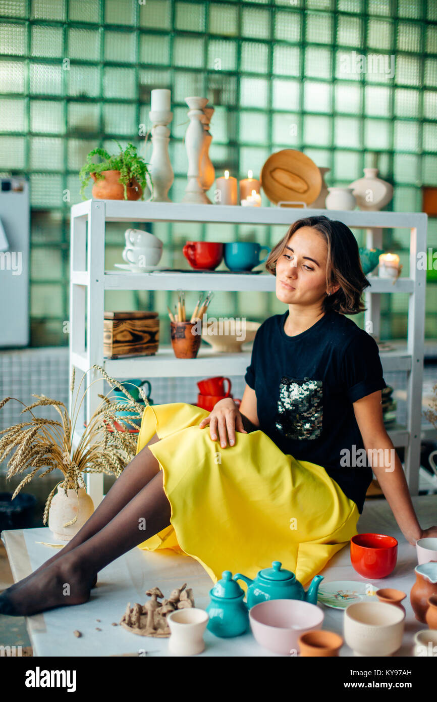 Pretty woman potter with clay cup Stock Photo - Alamy