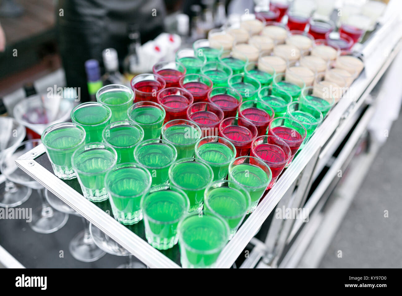 row line of different colored alcoholic cocktails on a party. wedding ...