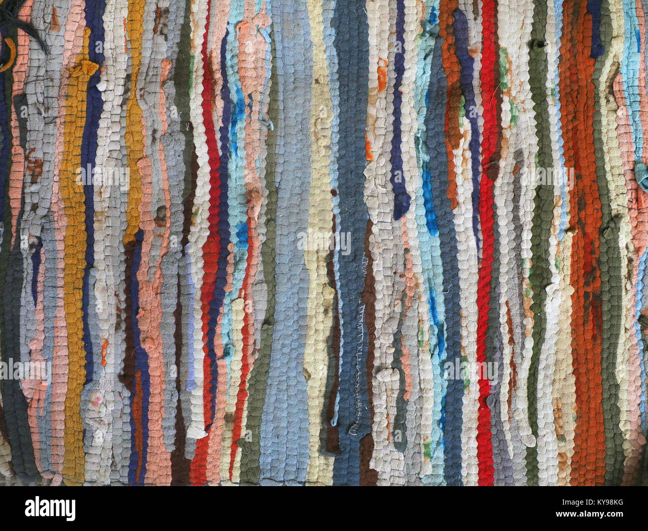 Bright colored background of strips of homespun rug, stripes ...