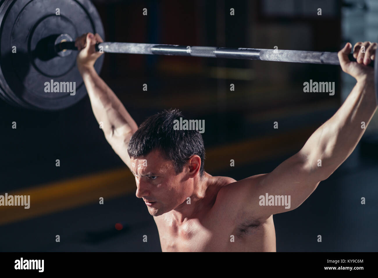 fitness man lifting heavy barbell at gym Stock Photo - Alamy