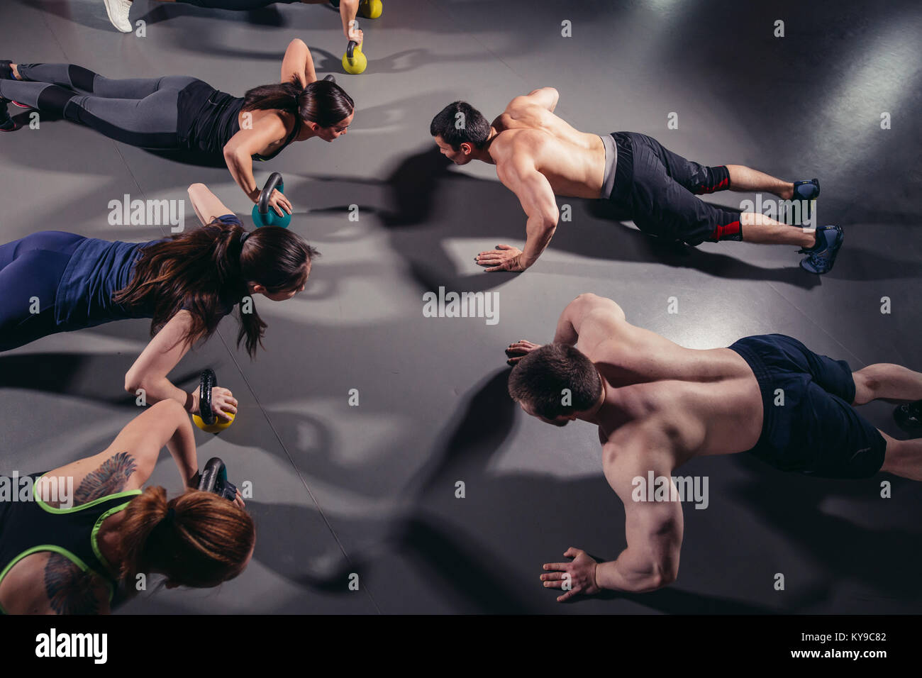 Group adults doing push up exercises indoor Stock Photo - Alamy