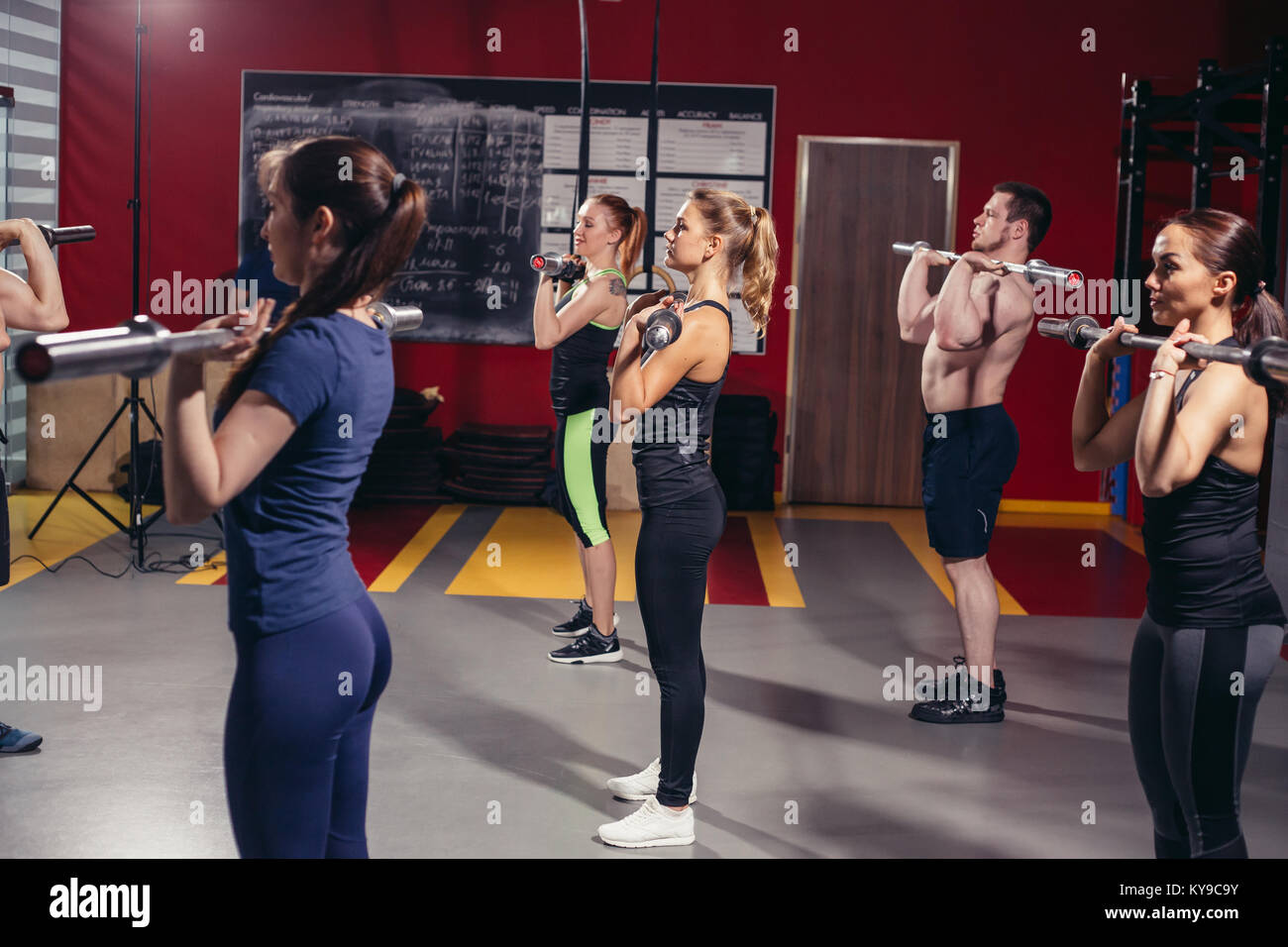 people doing exercise with barbell in gym Stock Photo - Alamy