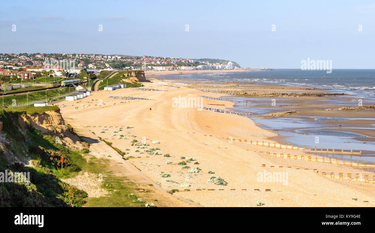 A train runs alongside the beach at St Leonards in East Sussex, England ...