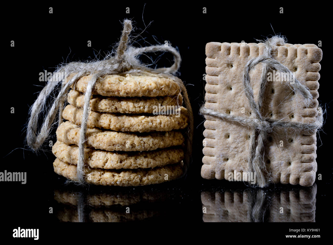Crumbly biscuits tied with a string on a glass table. Tasty cakes on a ...