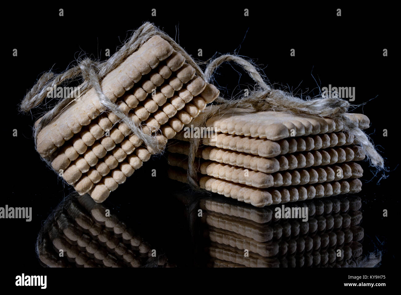 Crumbly biscuits tied with a string on a glass table. Tasty cakes on a ...