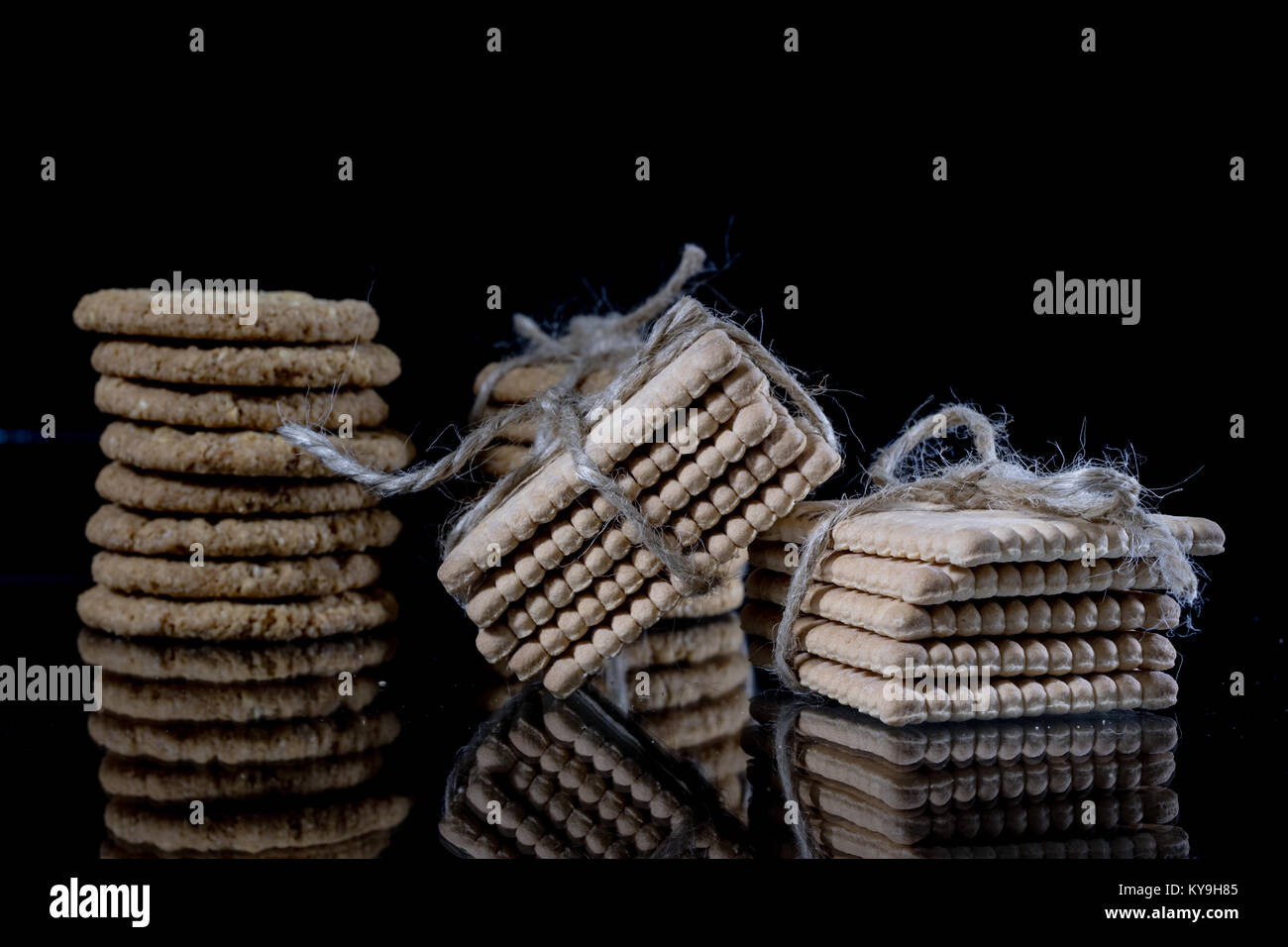 Crumbly biscuits tied with a string on a glass table. Tasty cakes on a ...