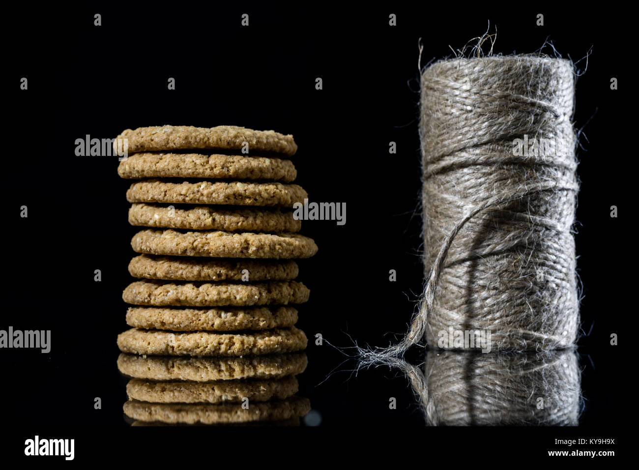 Crumbly biscuits tied with a string on a glass table. Tasty cakes on a ...