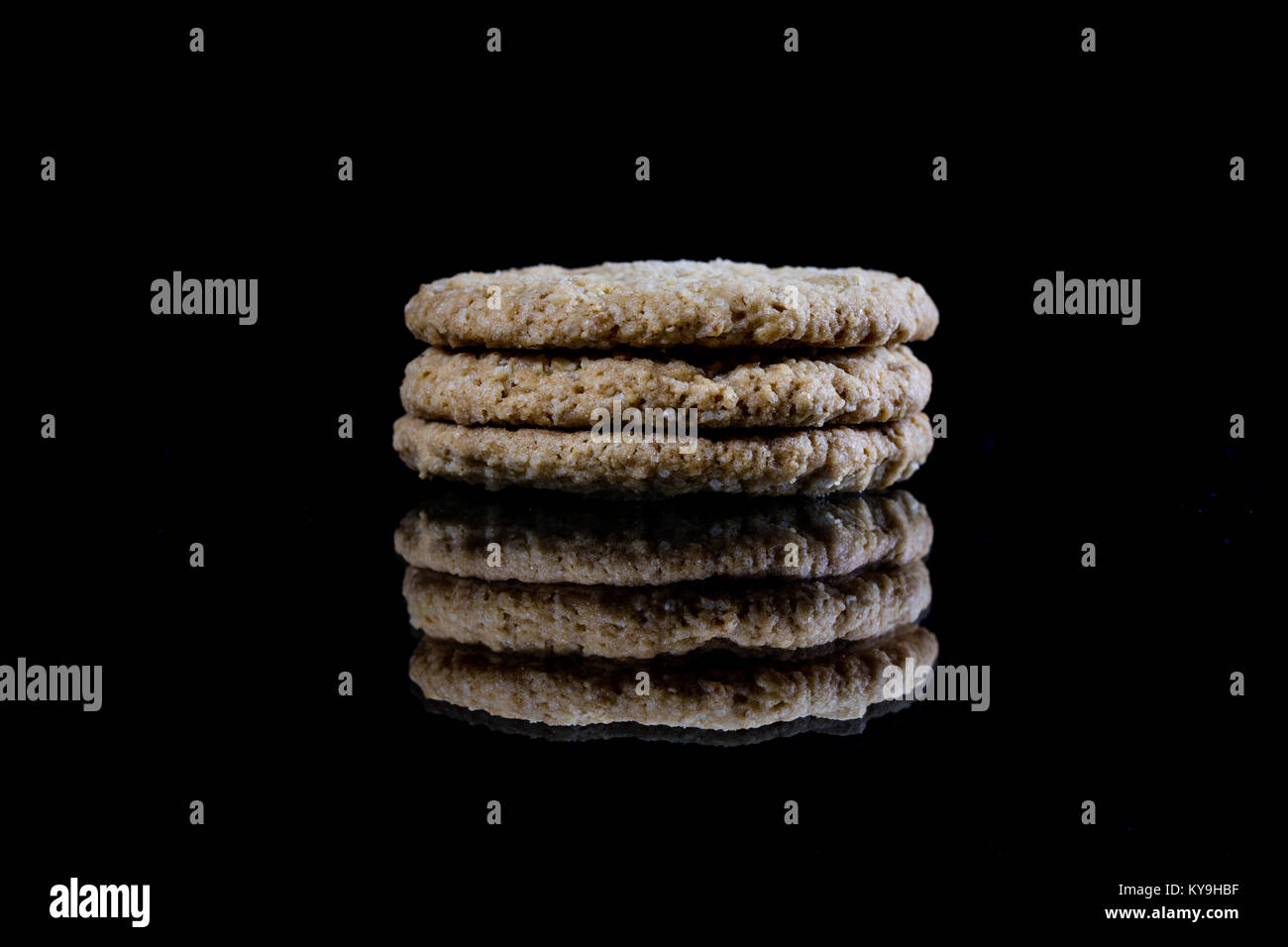 Crumbly biscuits tied with a string on a glass table. Tasty cakes on a ...