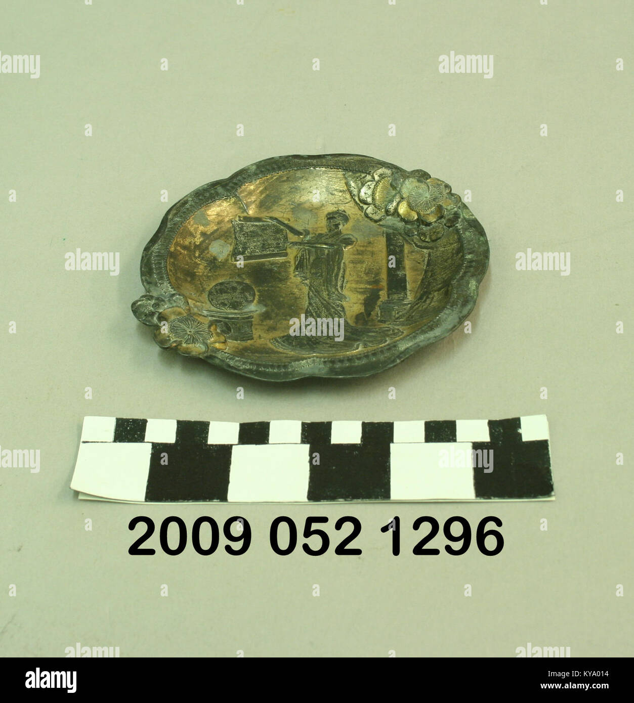 This round metal pin tray features a raised image depicting a 'Deed of ...