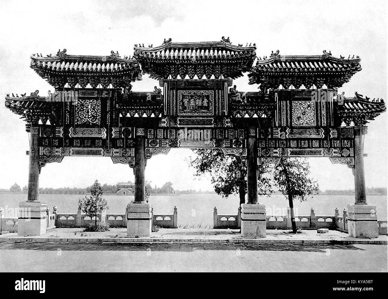 This image features the Pailou gate located by a lake in front of the ...