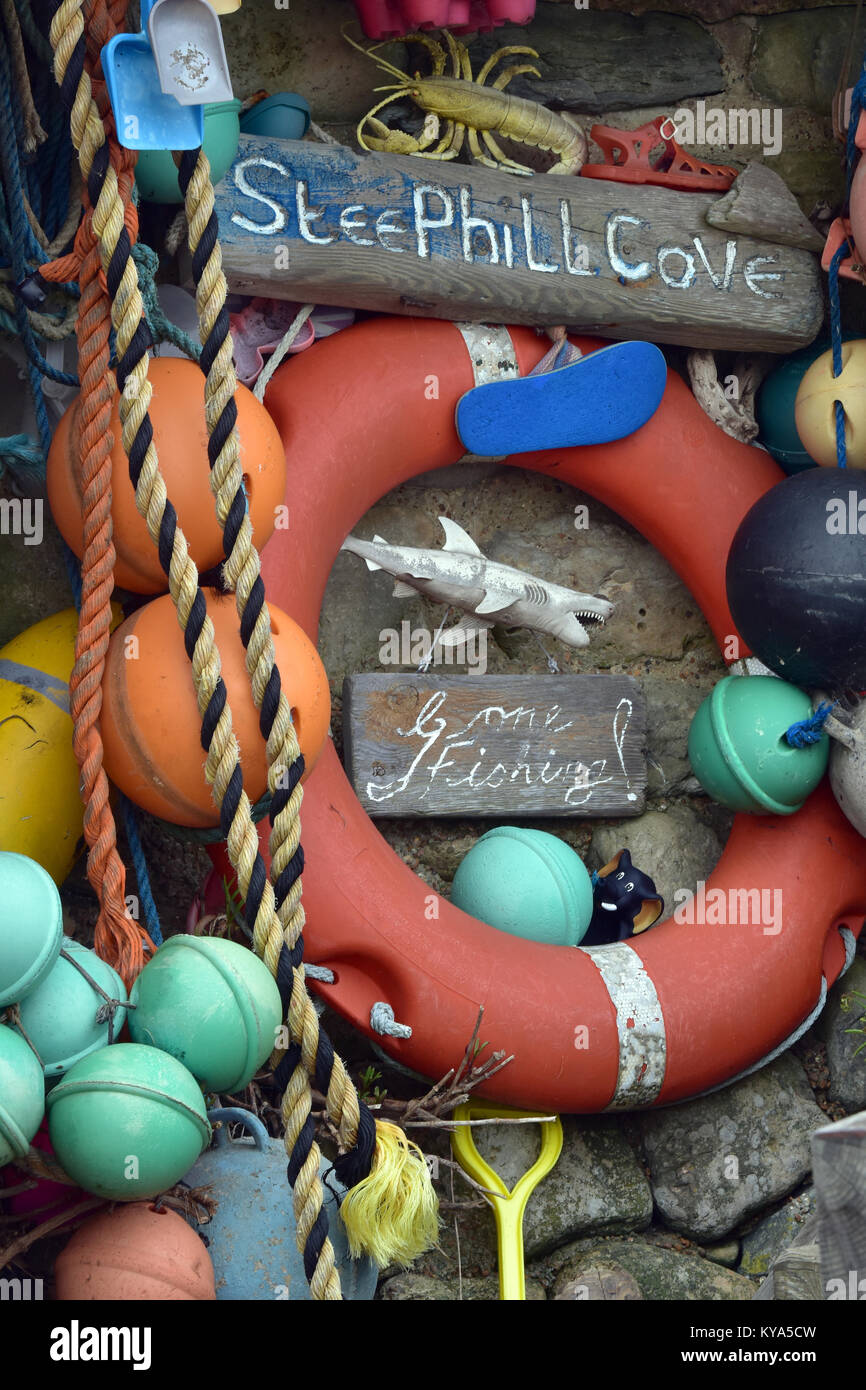 Old fishing floats and driftwood in a display of coastal or marine ...