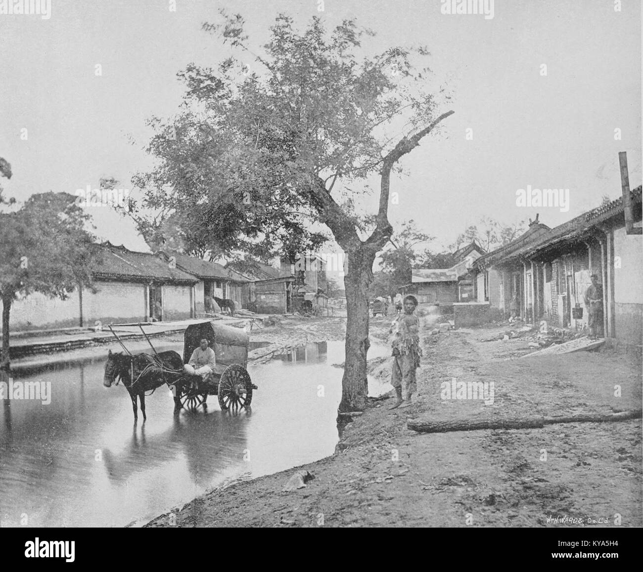 This photograph captures a street scene in Beijing (Pekin) after a ...