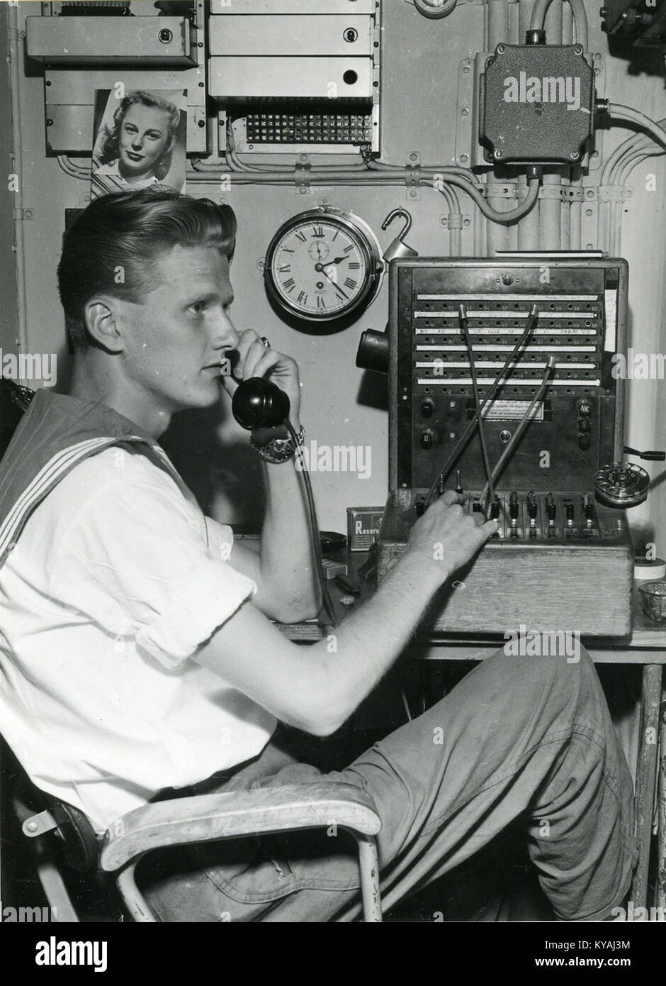 This photograph captures a telephone operator working aboard the ...