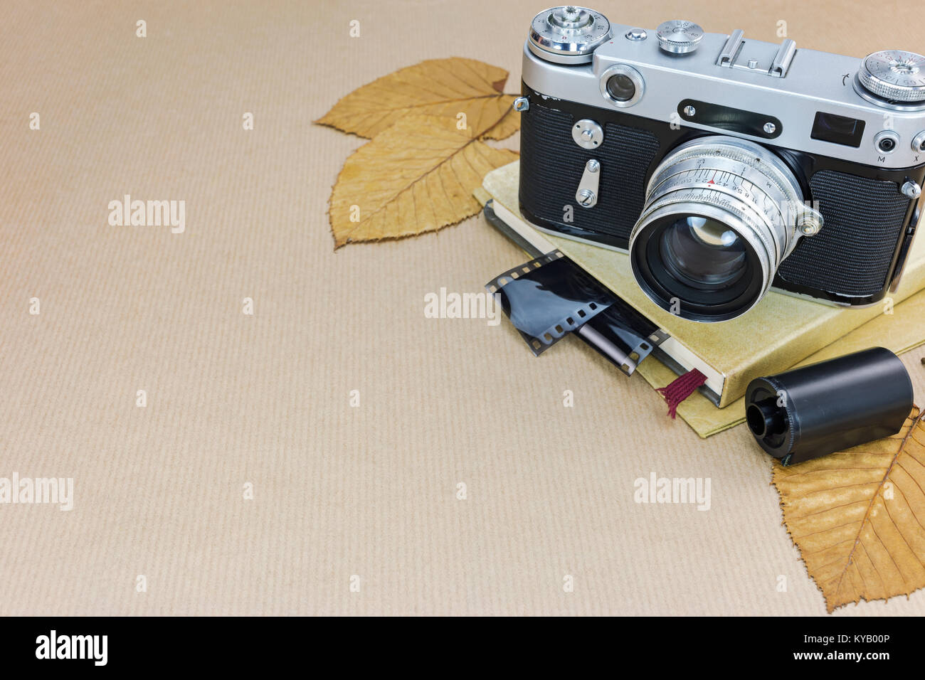 classic camera, negative films, roll and notebooks on paper background ...
