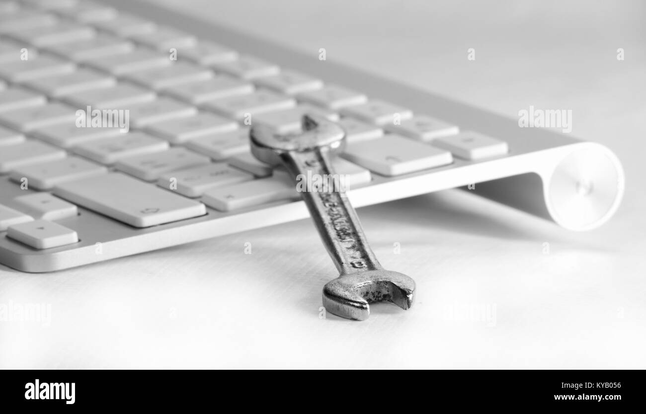 A keyboard with a wrench key Stock Photo - Alamy