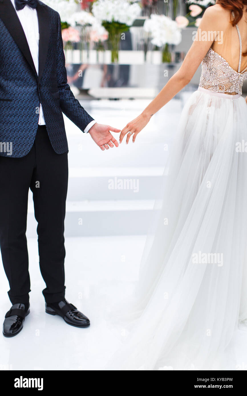 Young newlyweds walking outside and hold hands Stock Photo - Alamy