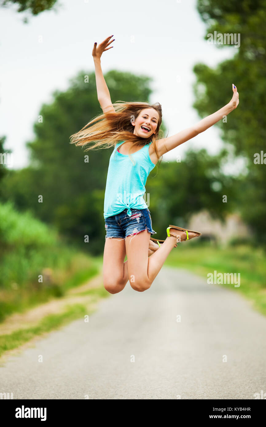 Happy girl jumping Stock Photo - Alamy