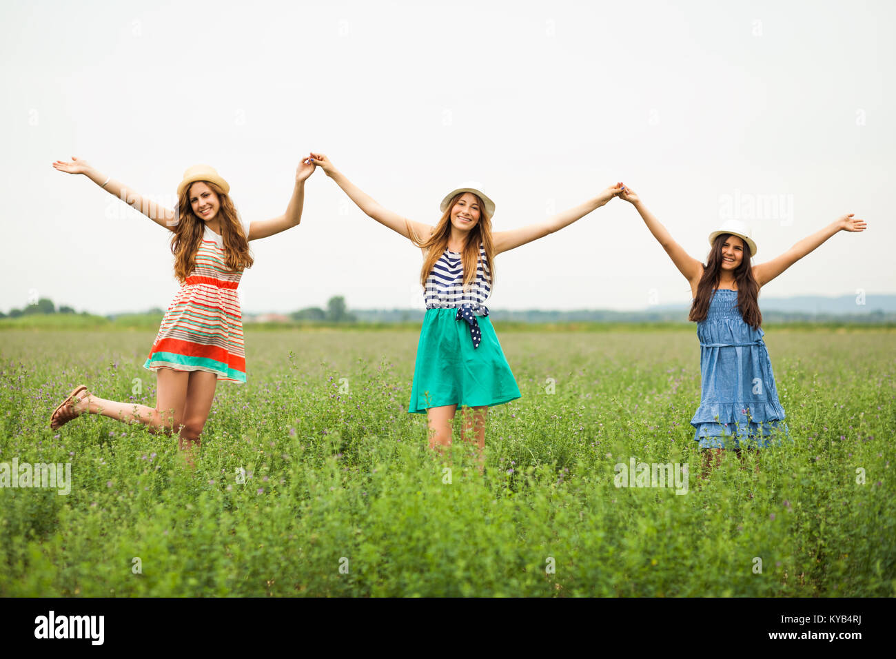 Happy girls smiling in wheat field Stock Photo - Alamy