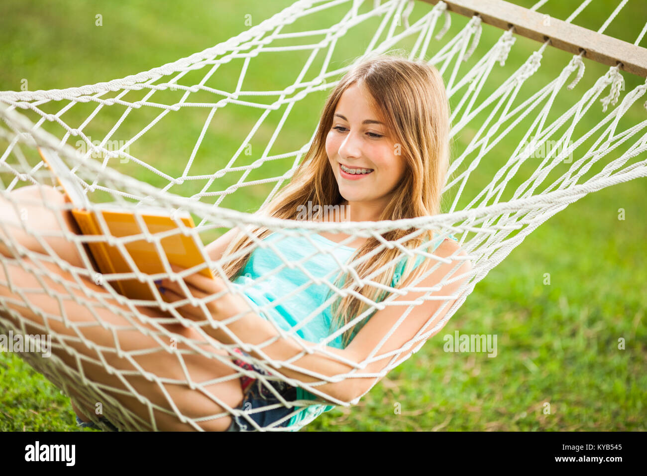 Teenager reading book in hammock hi-res stock photography and images ...