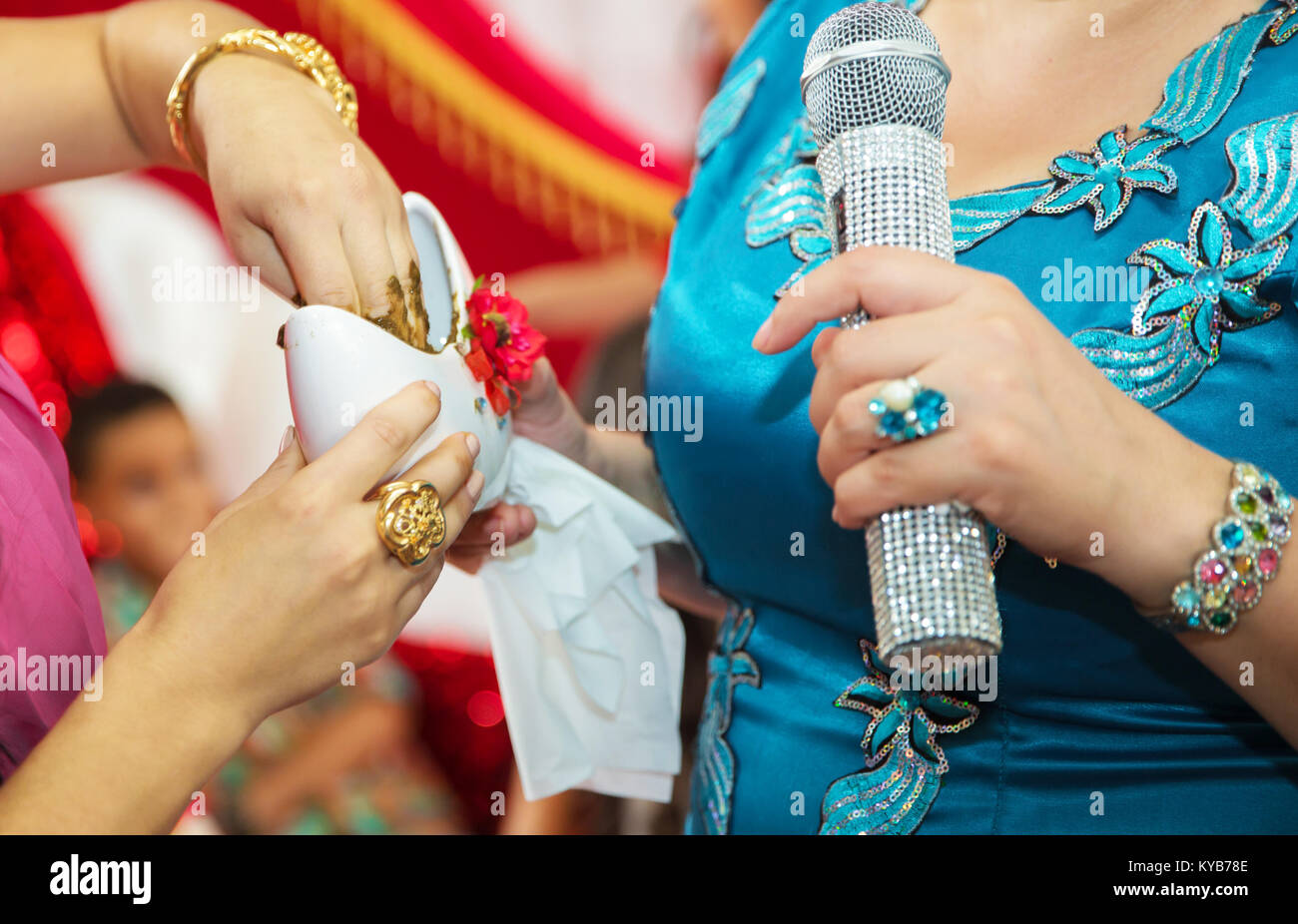 Henna extracts from the container . They put their hands henna of the ...
