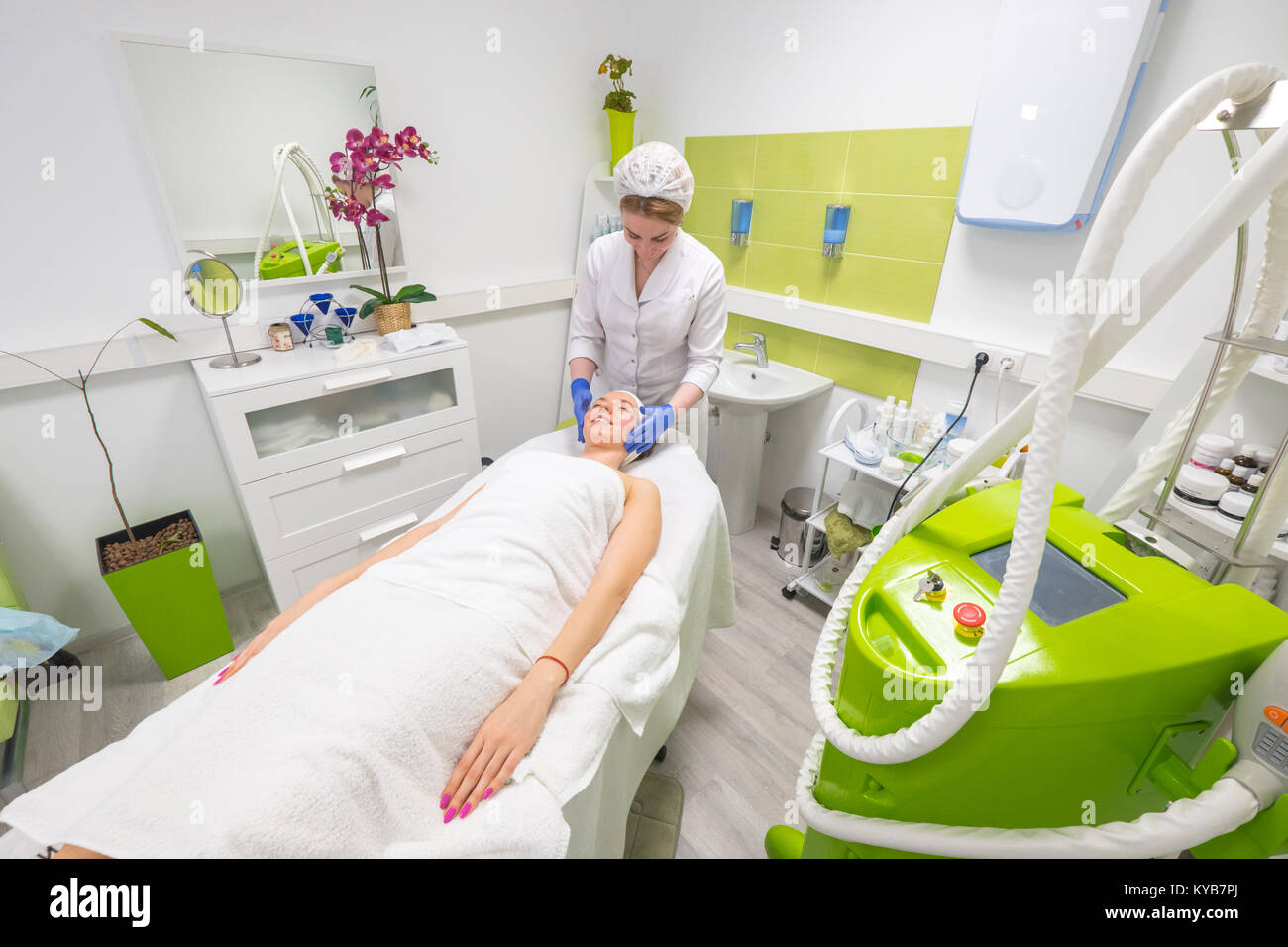 Doctor massaging patient's face. Model and doctor. Cosmetological ...