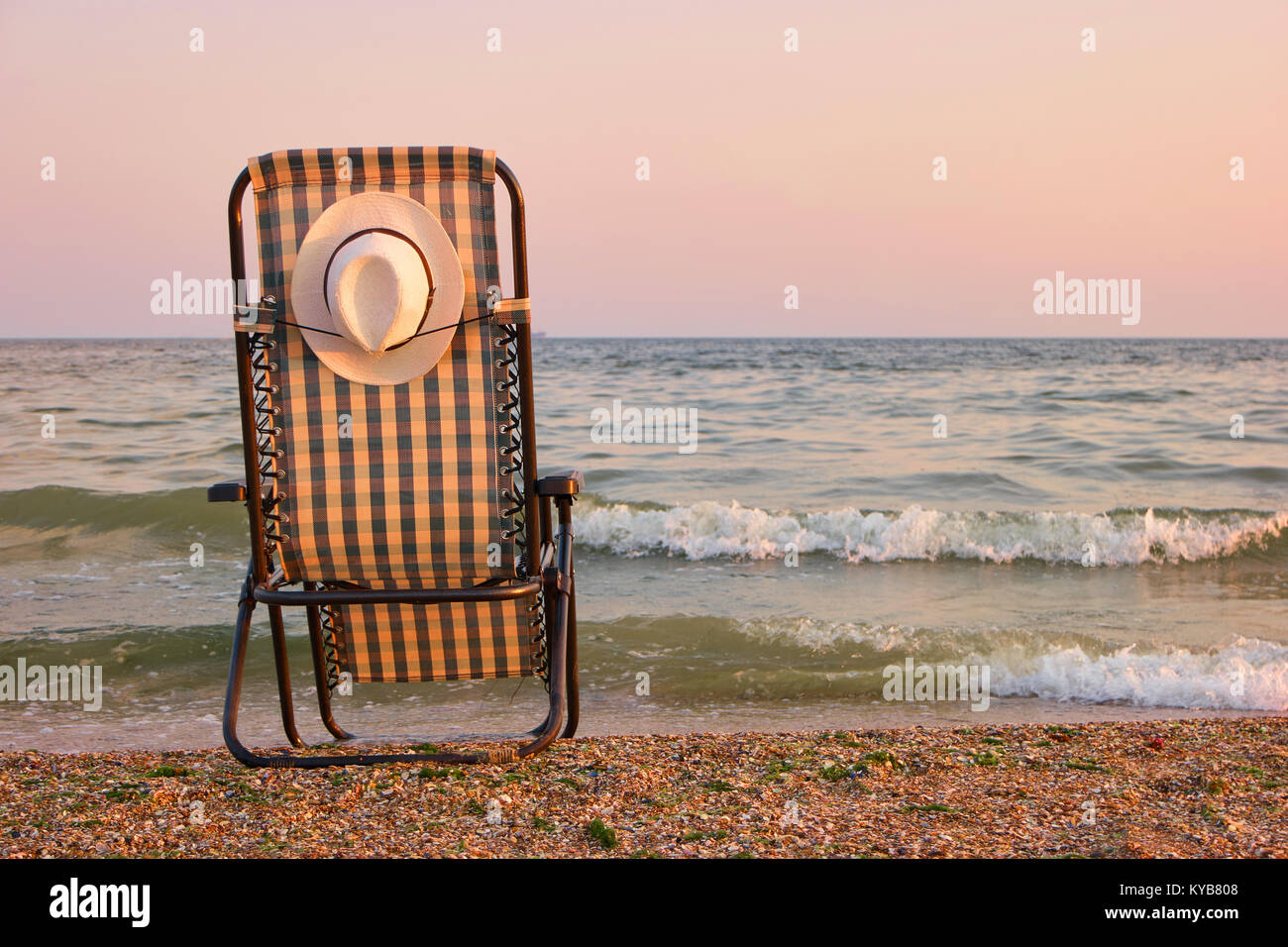 Rear view beach recliner in sea wave background Stock Photo - Alamy