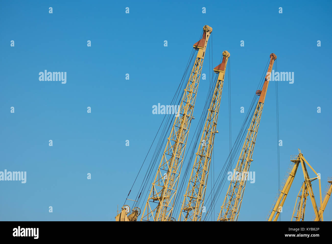 Yellow crane against blue sky Stock Photo - Alamy