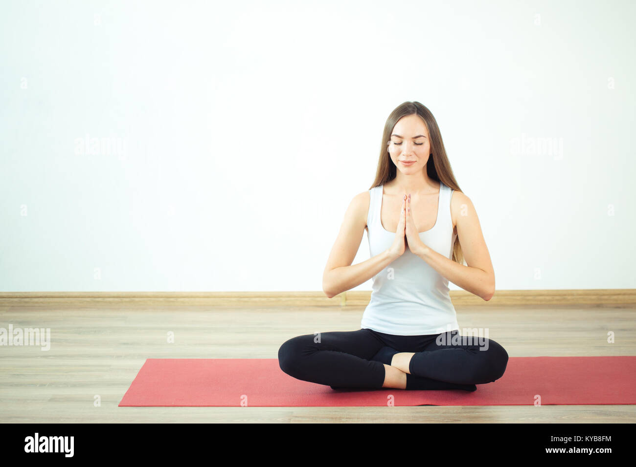 woman practicing yoga, sitting in Padmasana, exercise, Lotus pose ...