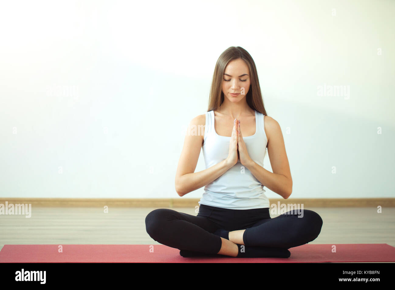 woman practicing yoga, sitting in Padmasana, exercise, Lotus pose ...