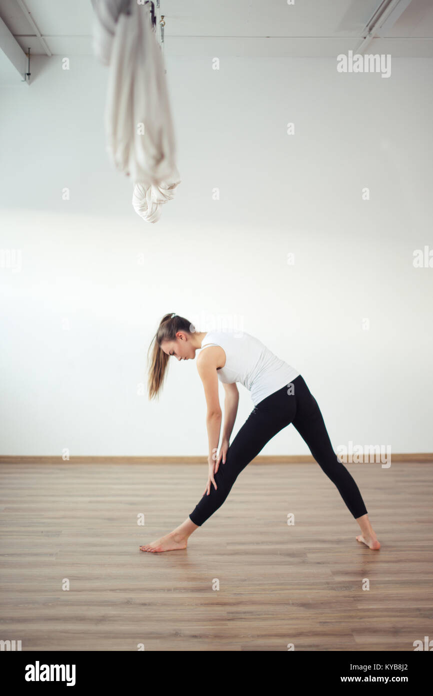 young woman enjoying yoga indoors. Revolved Triangle Pose, Parivrrta ...