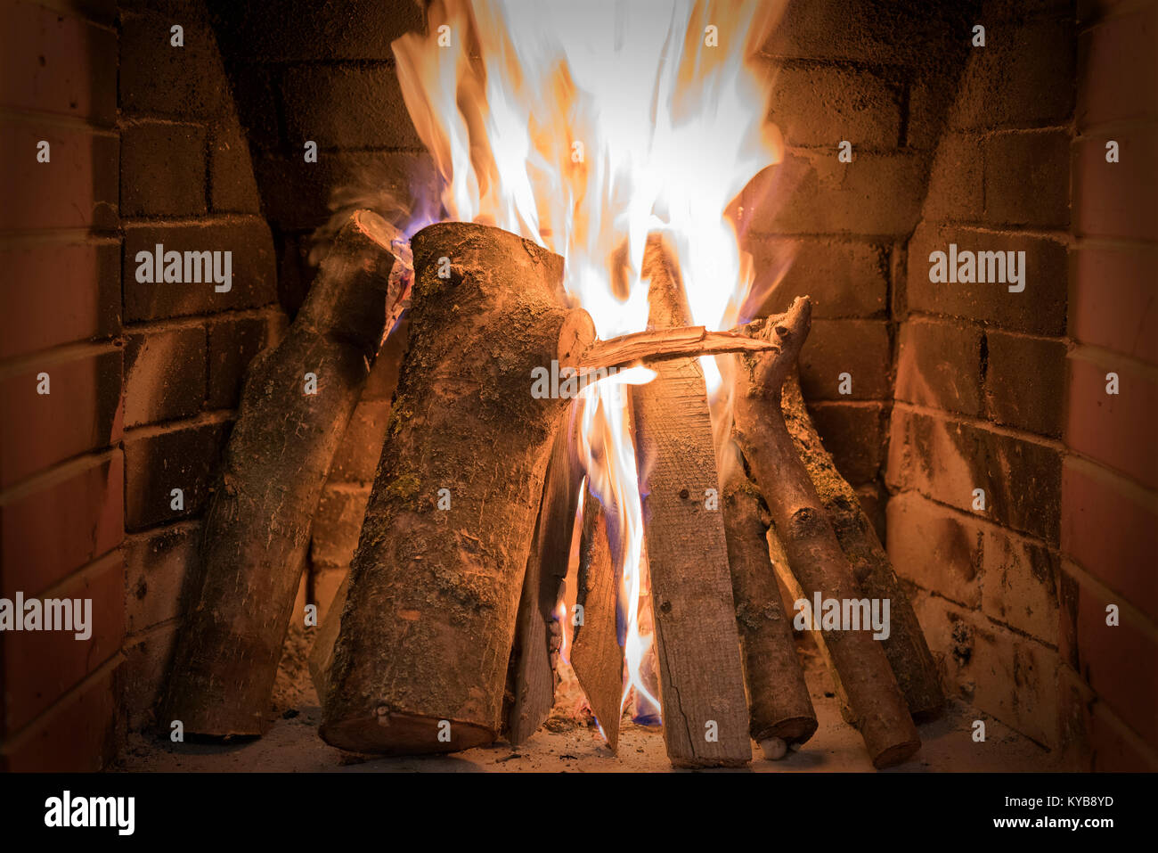 Firewood burns in red brick hi-res stock photography and images - Alamy