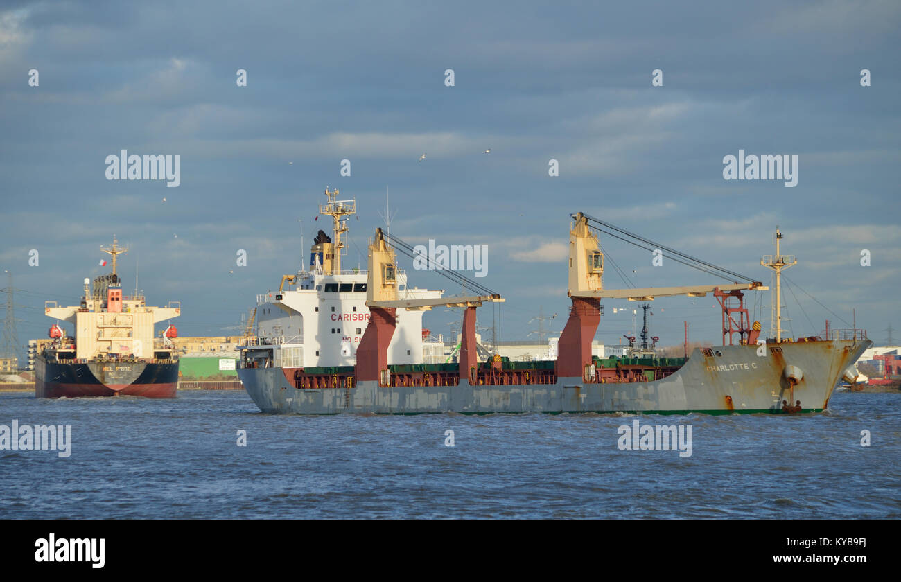 Two large cargo ships passing each other on the River Thames in East ...