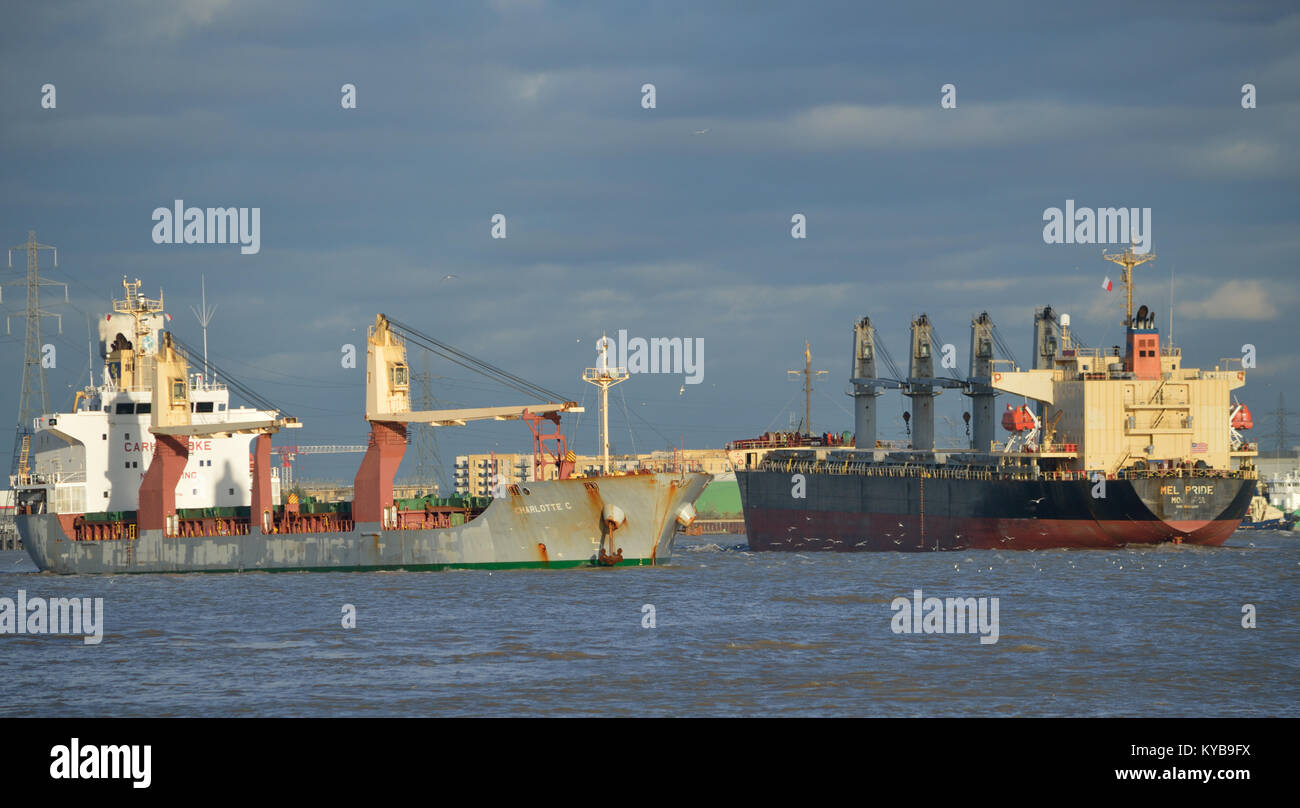 Two large cargo ships passing each other on the River Thames in East ...