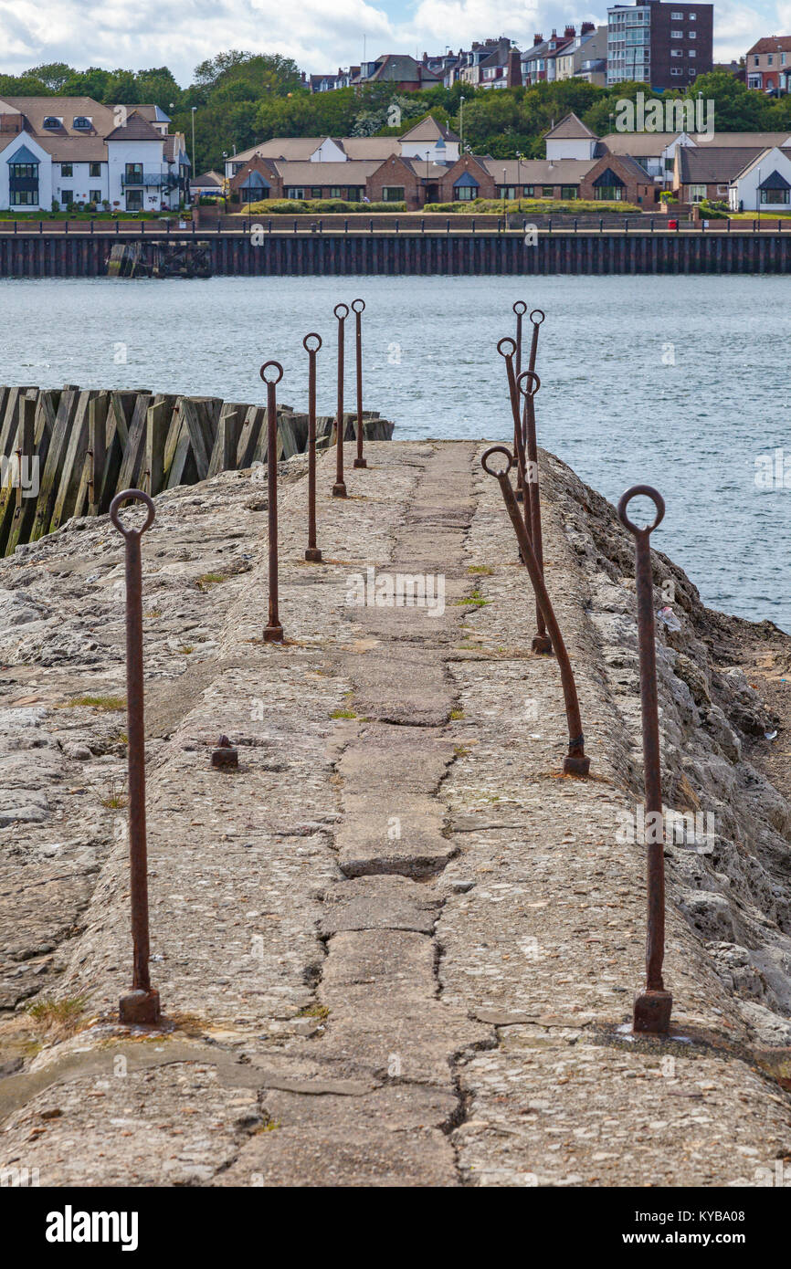 A breakwater leads out into the River Tyne near the Fish Quay, made of ...
