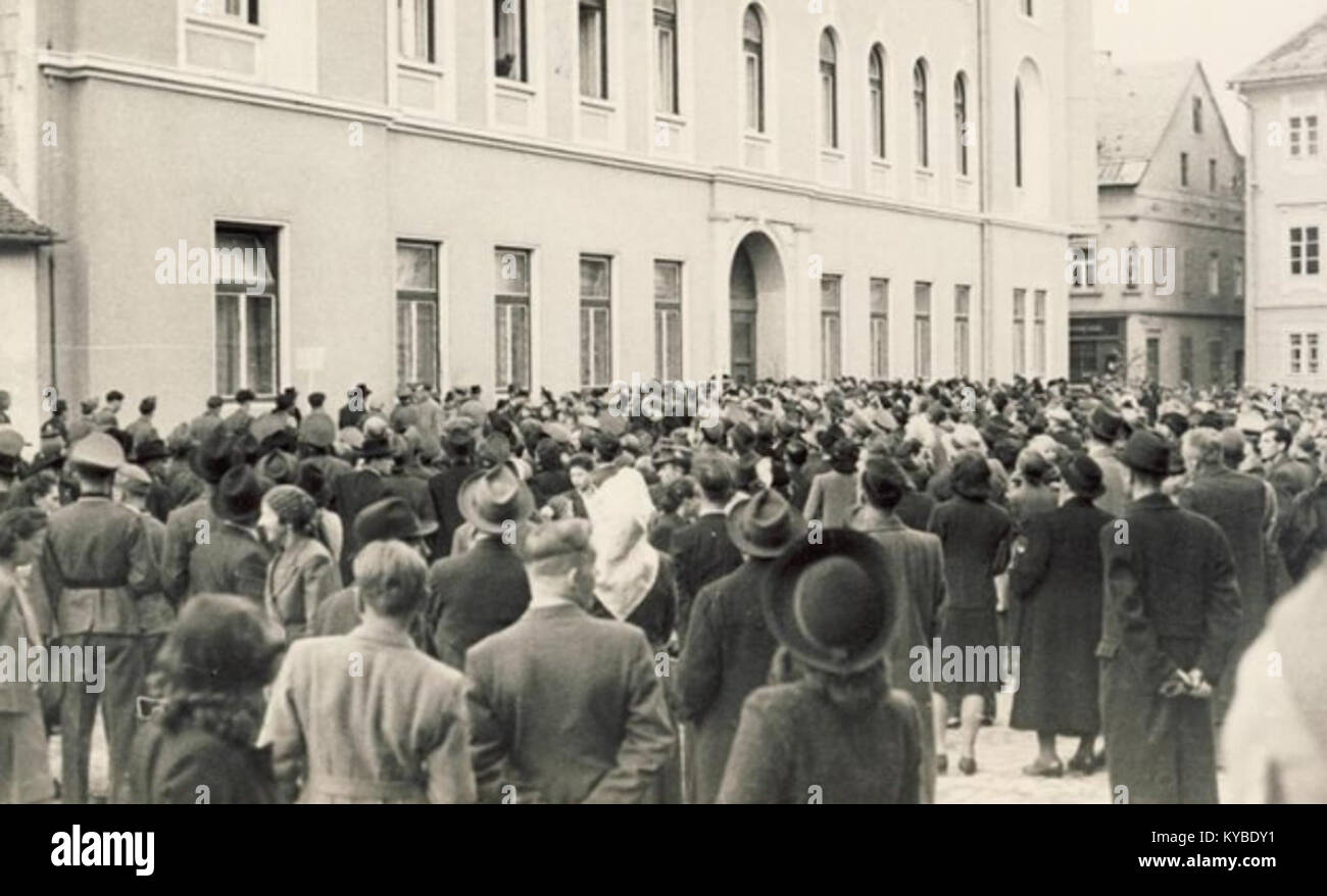 A historical photograph showing a crowd gathered around captured and ...